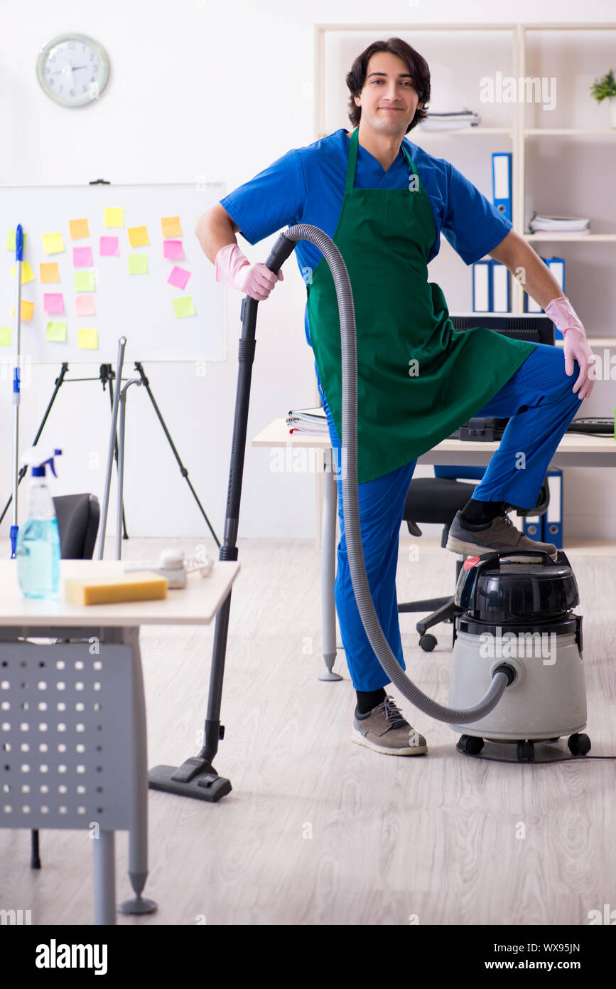 Male handsome professional cleaner working in the office Stock Photo ...