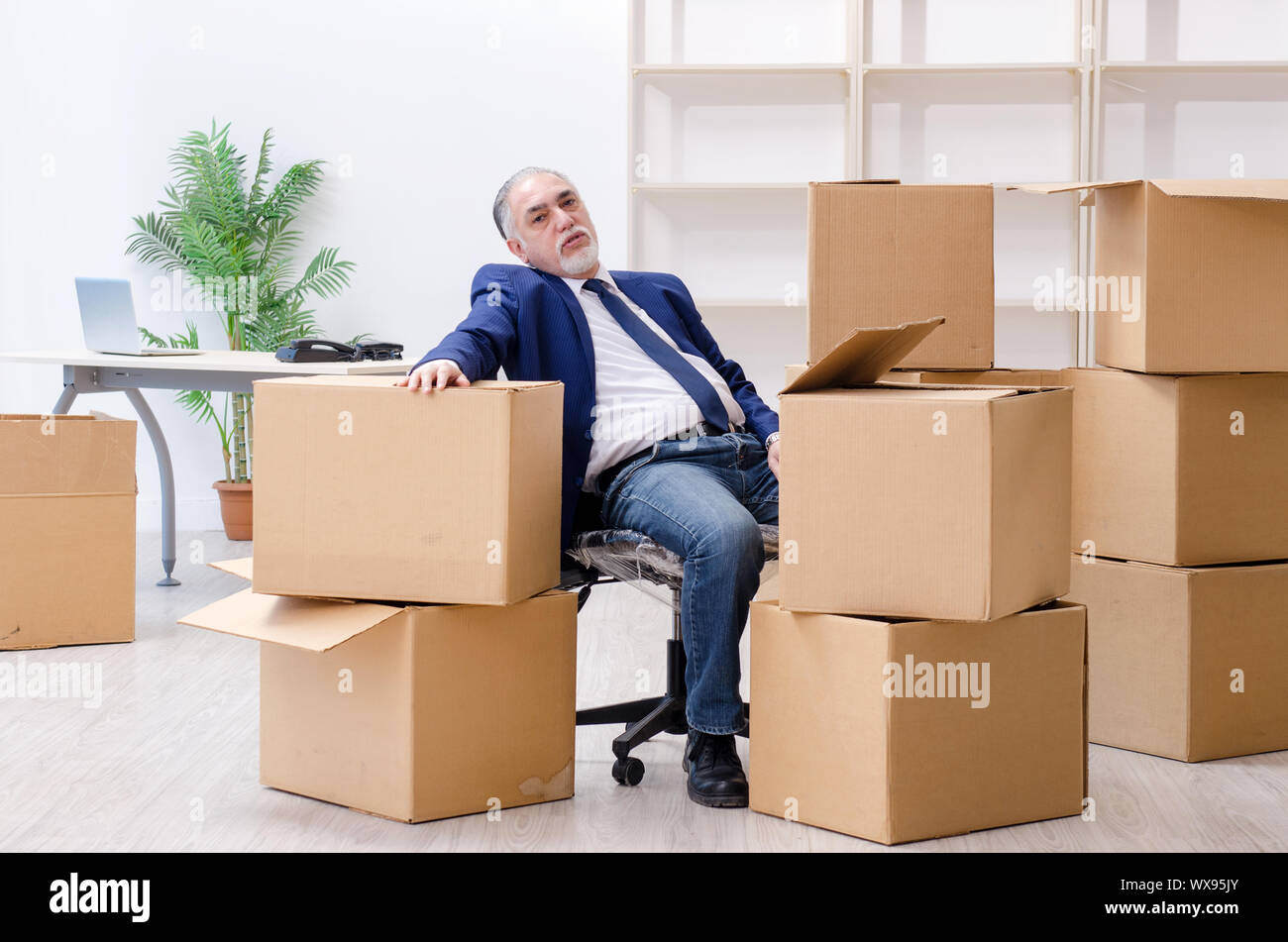 Aged businessman moving to new workplace Stock Photo - Alamy