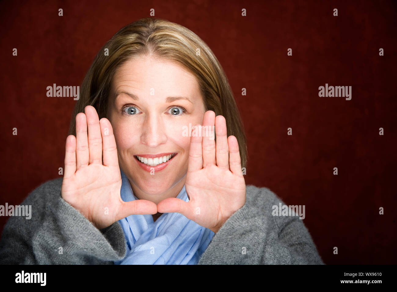 Pretty woman framing her face with her hands Stock Photo - Alamy