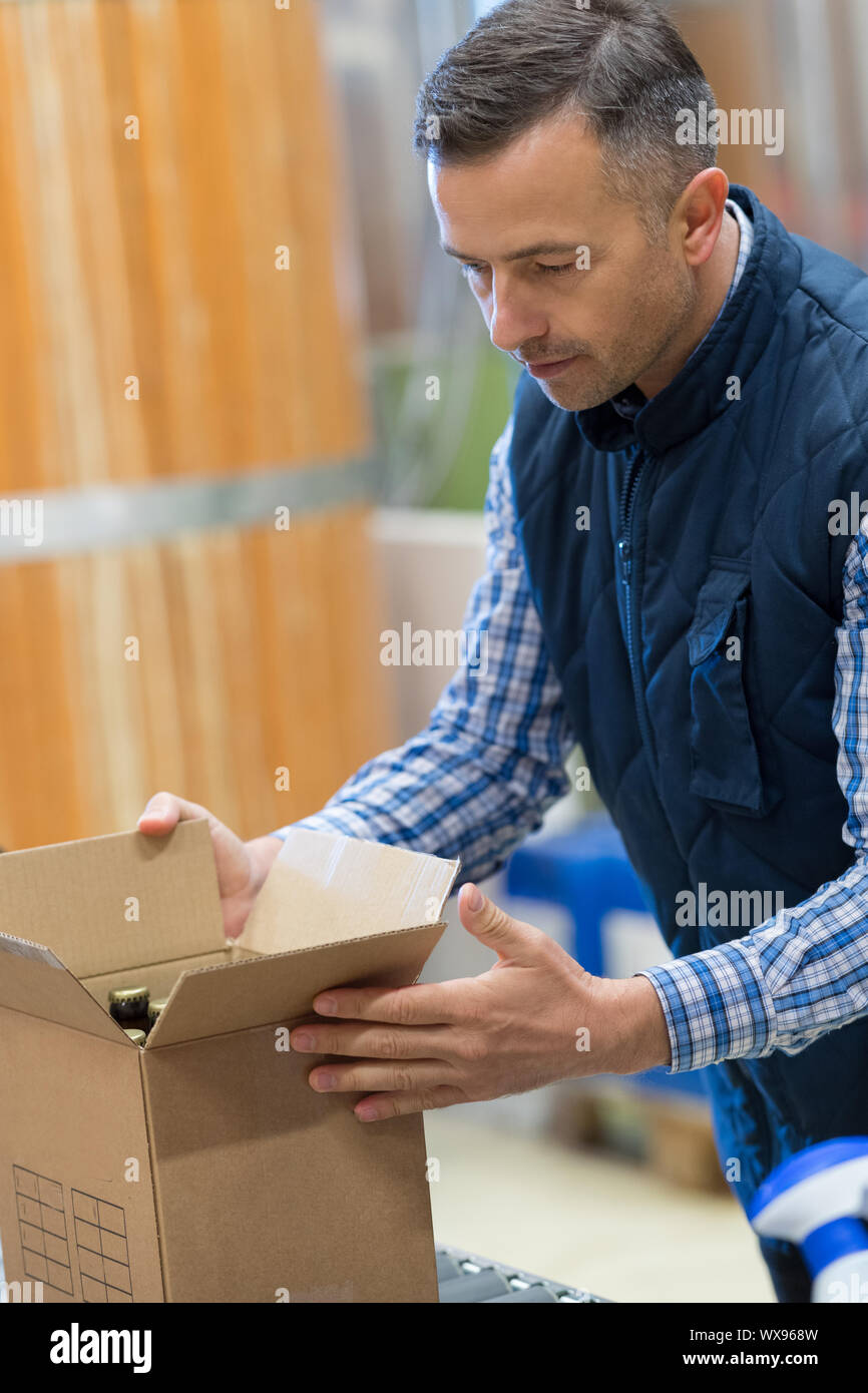 porter carrying boxes in a warehouse Stock Photo - Alamy
