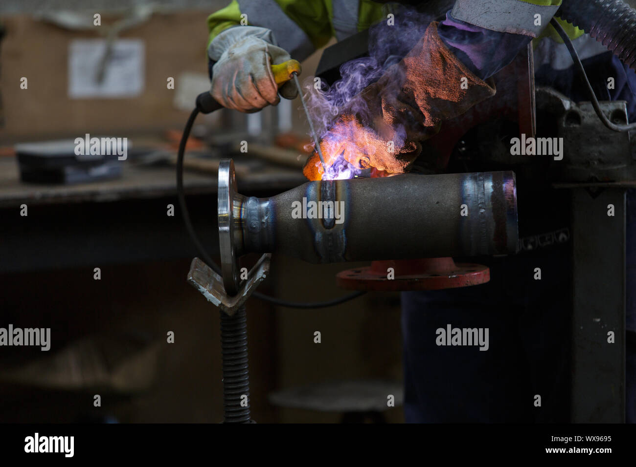 man soldering metal in a factory Stock Photo - Alamy