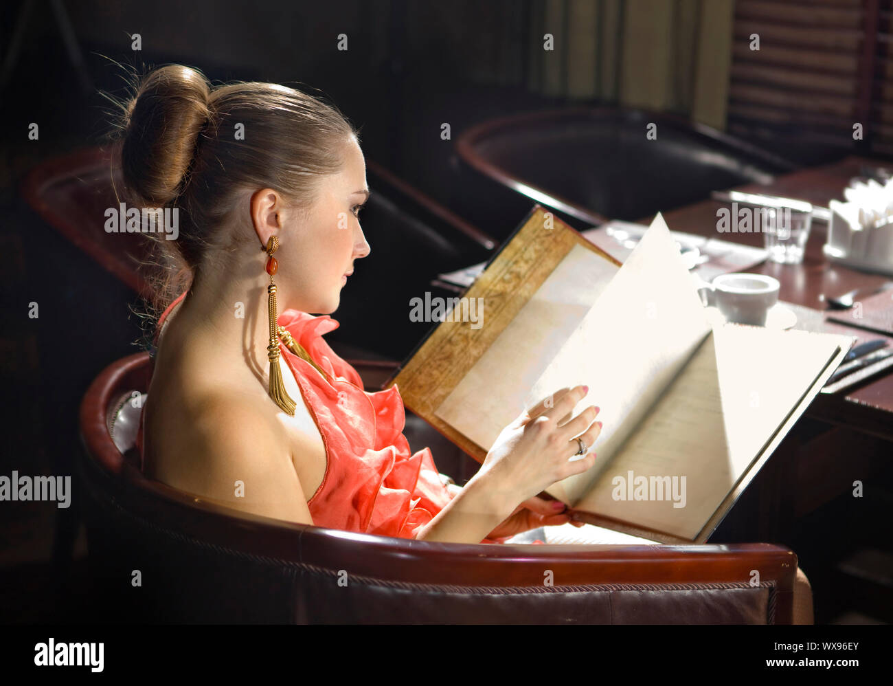 beautiful woman looks on menu at expensive restaurant Stock Photo - Alamy