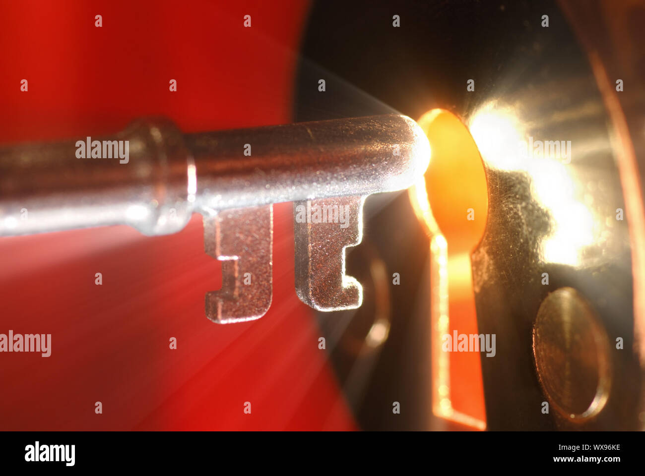 Key & keyhole with light coming from it Stock Photo - Alamy