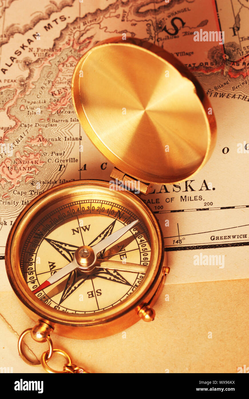 Antique brass compass over old Alaska map Stock Photo - Alamy
