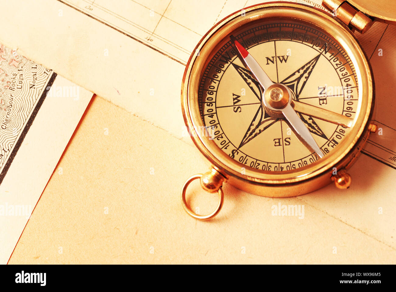Antique brass compass over old map background Stock Photo - Alamy