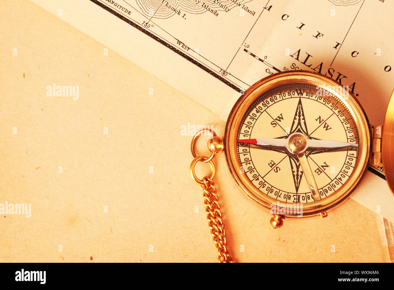 Antique brass compass over old Alaska map Stock Photo - Alamy