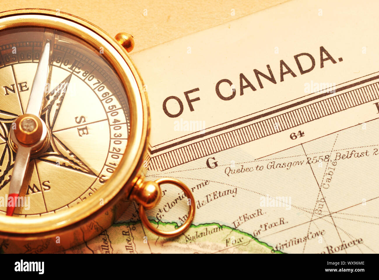 Antique brass compass over old Canadian map background Stock Photo - Alamy