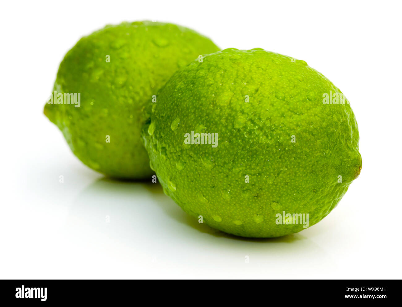 Lime with water drops isolated on white background Stock Photo - Alamy