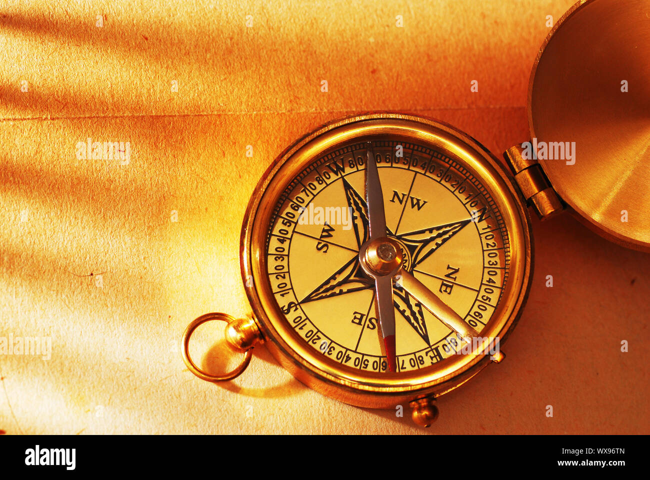 Antique brass compass over old map background Stock Photo - Alamy