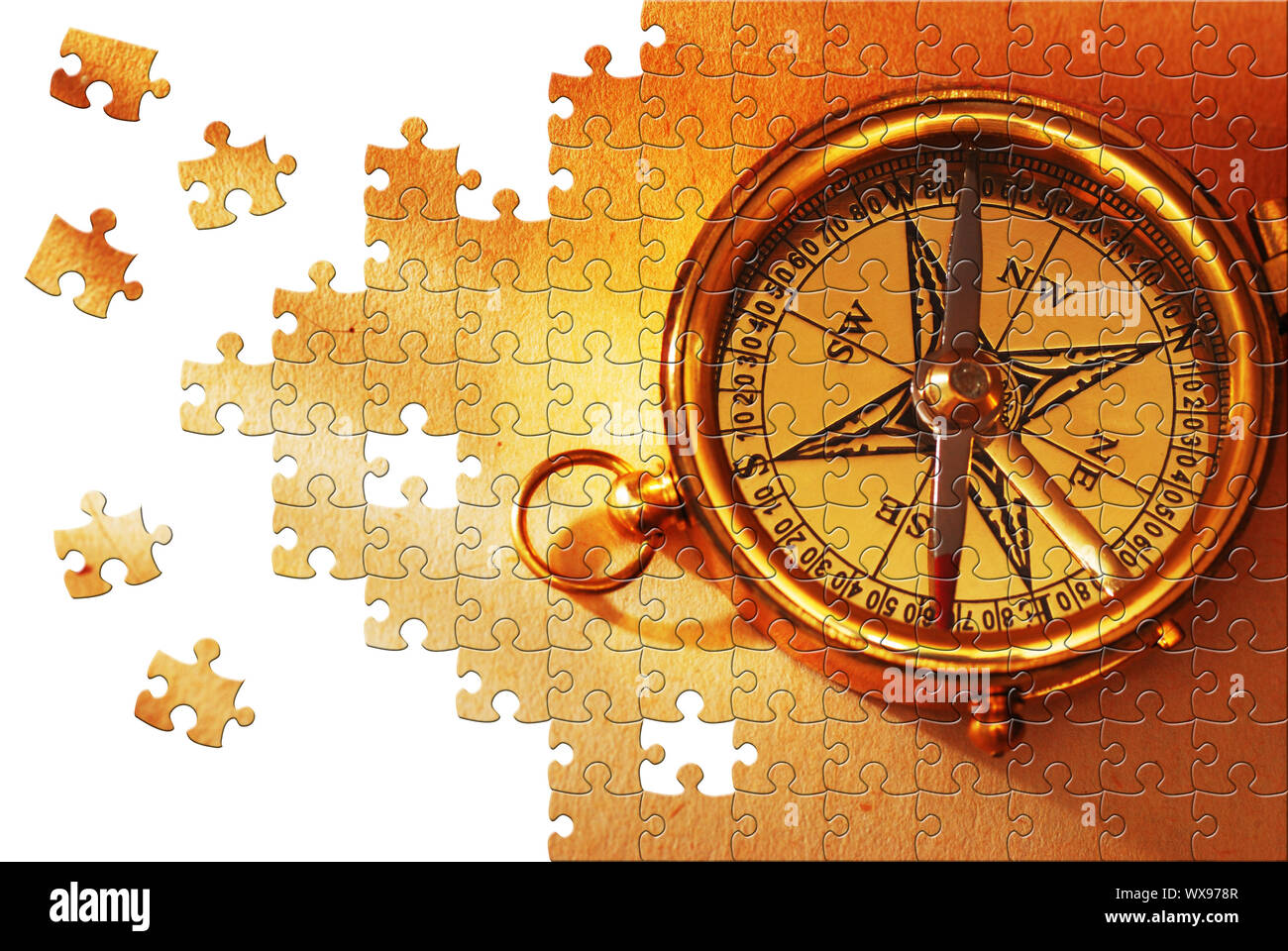 Puzzle Antique brass compass over old map background Stock Photo - Alamy