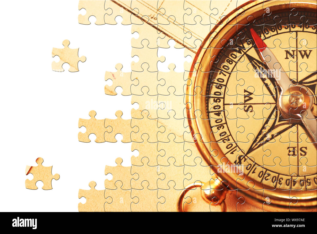 Puzzle Antique brass compass over old map background Stock Photo - Alamy
