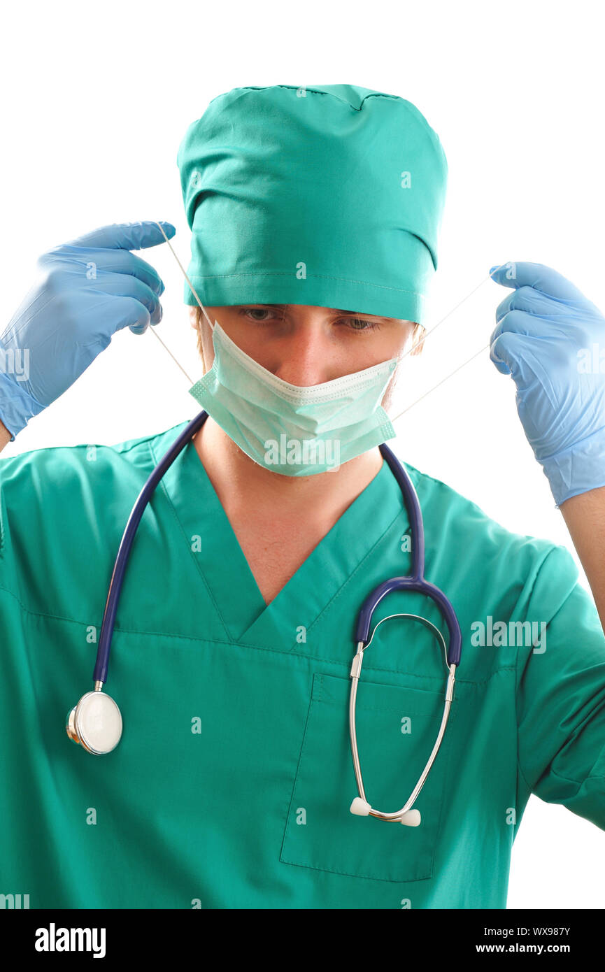 Doctor pulling on surgical mask Stock Photo - Alamy