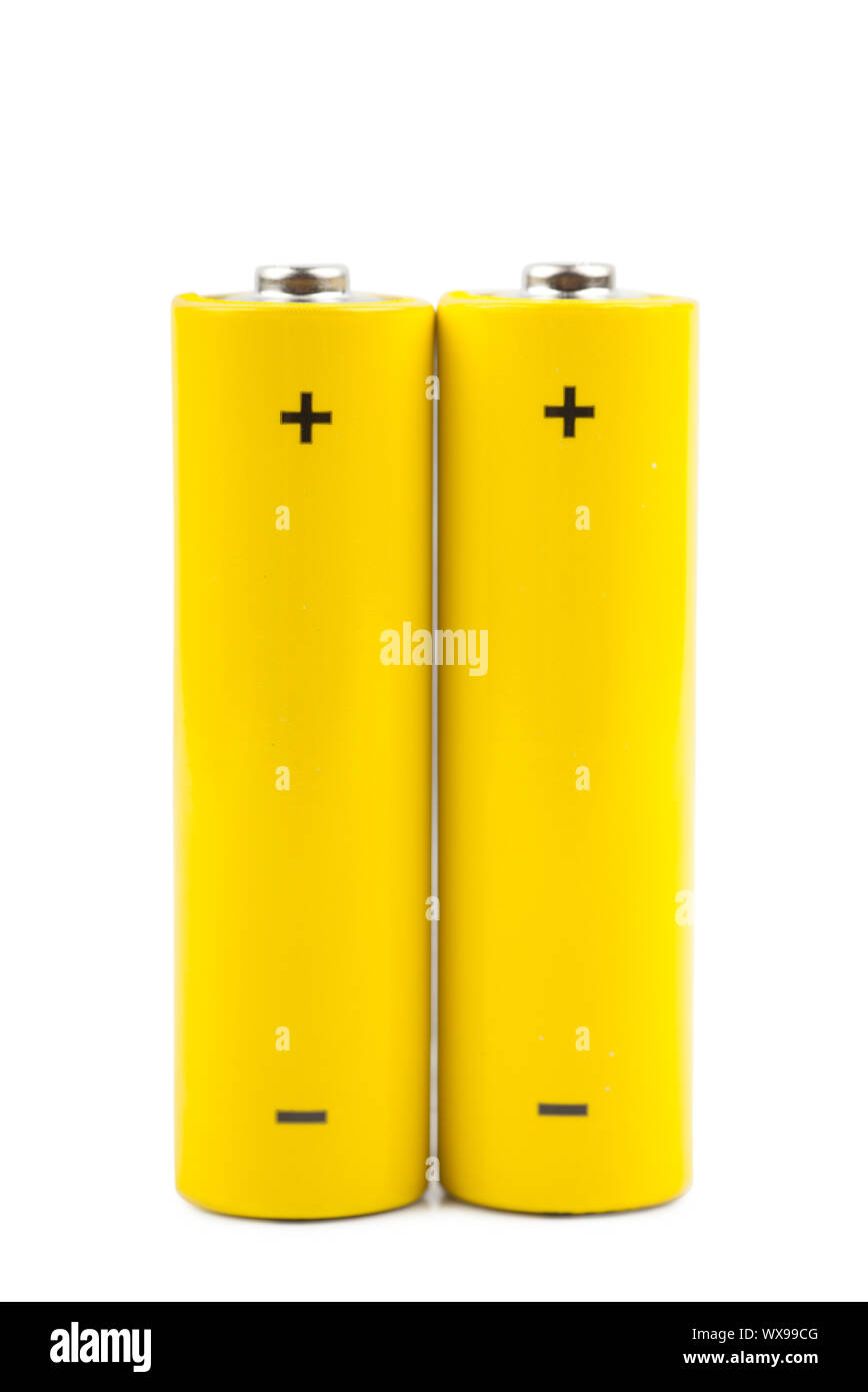 Two yellow batteries isolated over white background Stock Photo - Alamy