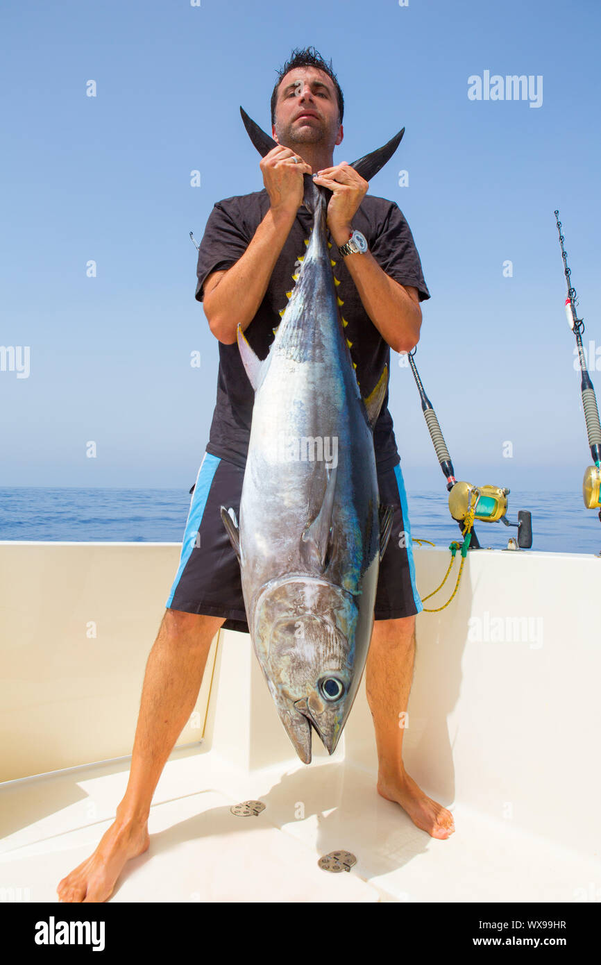 big Bluefin tuna catch by fisherman on boat trolling posing on deck ...