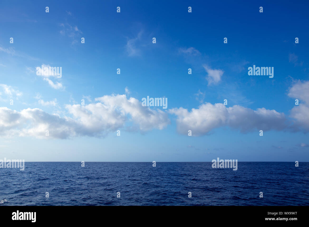 cumulus clouds in blue sky over ocean water horizon Stock Photo - Alamy