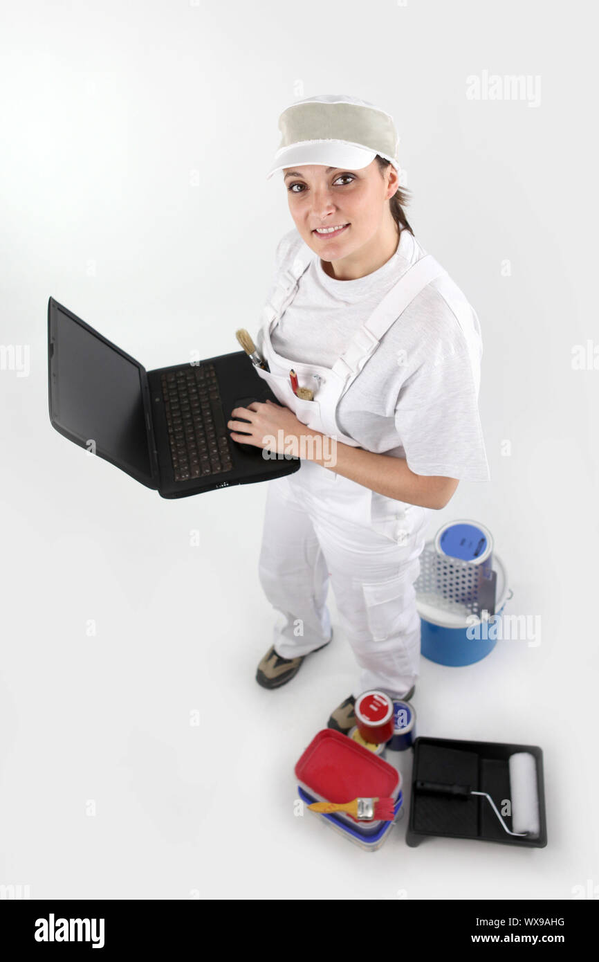 Female painter holding a computer Stock Photo - Alamy