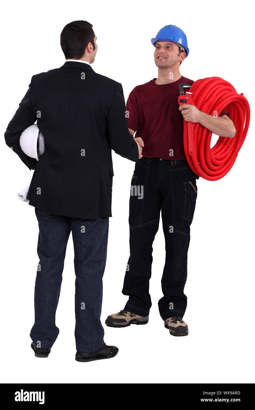 Architect shaking hands with a plumber Stock Photo - Alamy