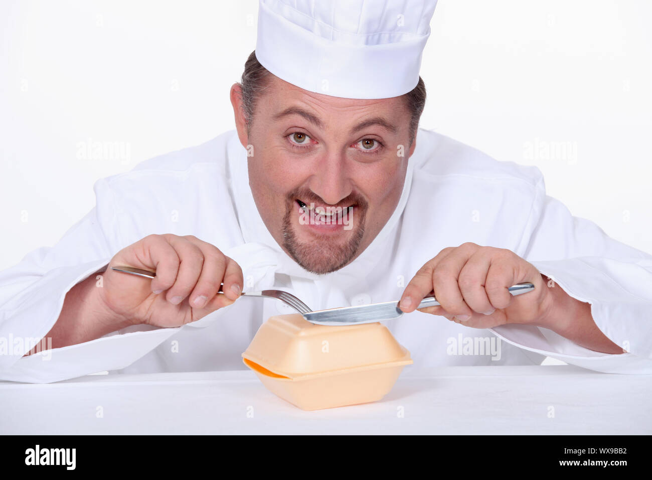 Chef eating a polystyrene foam takeaway box Stock Photo - Alamy