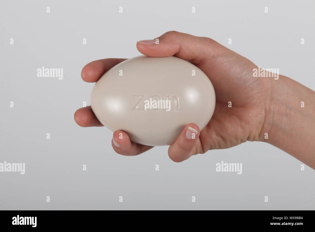 Hand holding pebble Stock Photo - Alamy
