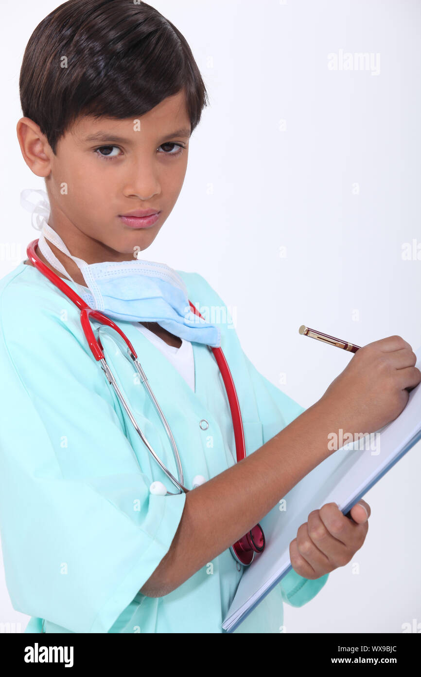 Little boy with chart dressed-up as doctor Stock Photo - Alamy