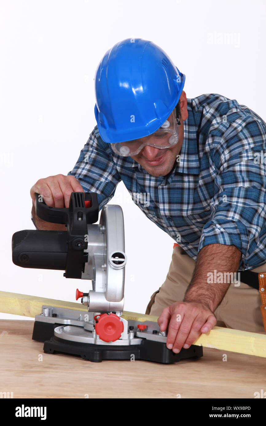 Carpenter using saw mounted to work surface Stock Photo - Alamy