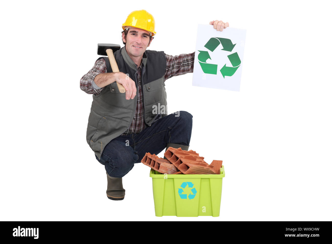 Builder recycling bricks Stock Photo - Alamy