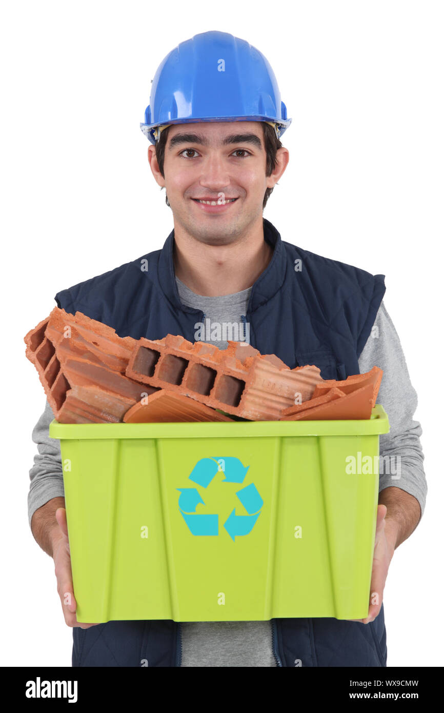 young bricklayer carrying recycling tub full of red bricks Stock Photo ...