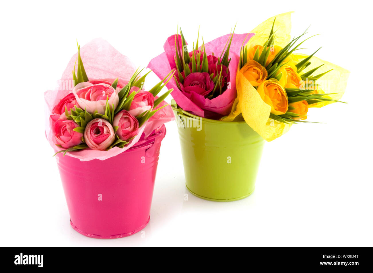 Pink and green bucket with flowers isolated Stock Photo - Alamy