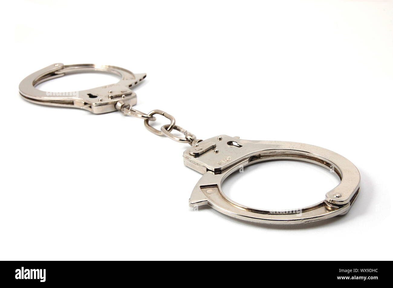 police handcuffs isolated on a white background Stock Photo - Alamy