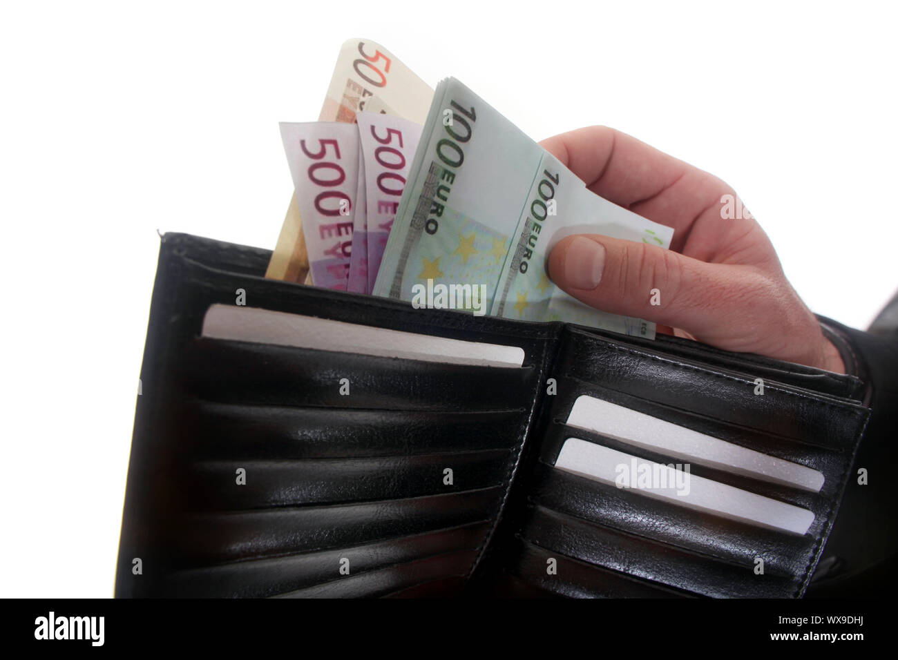 Hand taking notes out of a wallet Stock Photo - Alamy