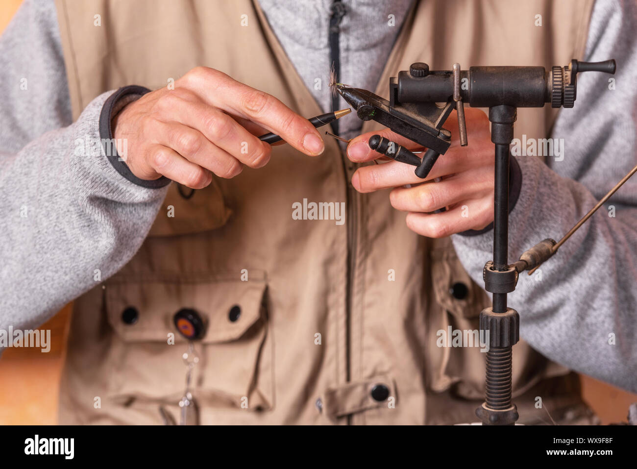 Hands tying hook hi-res stock photography and images - Alamy