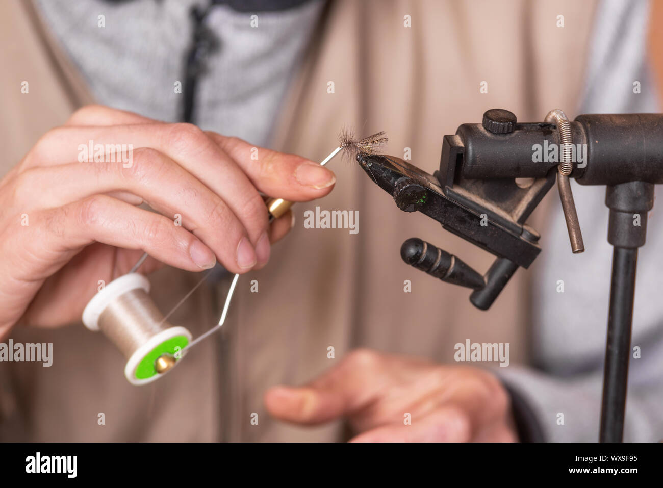 Hands tying hook hi-res stock photography and images - Alamy