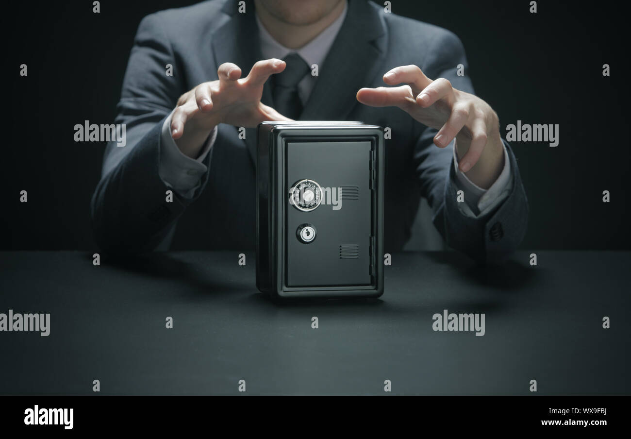 Hands reaching for a safe Stock Photo - Alamy