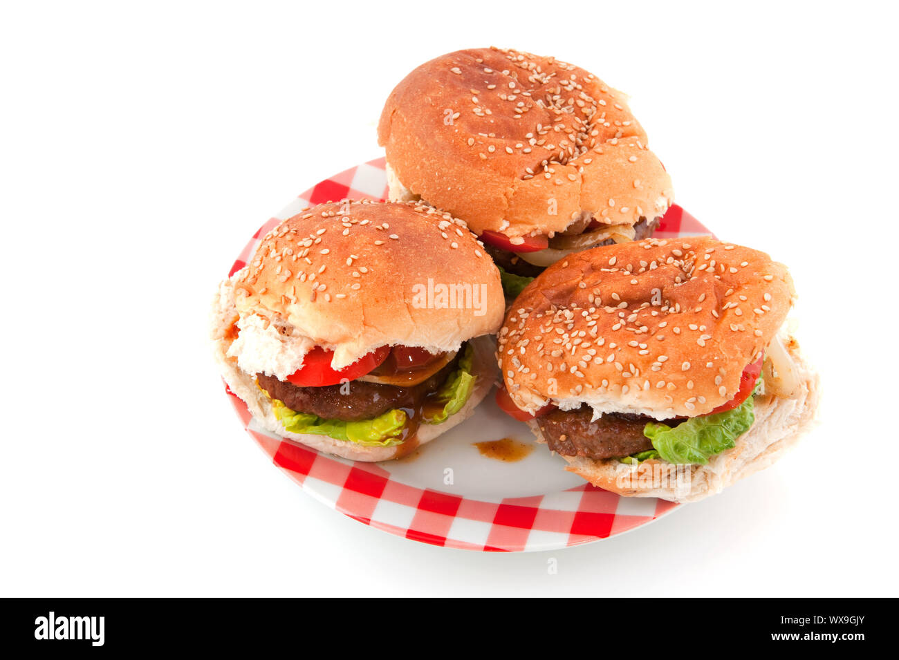 Three hamburgers on a checked plate isolated over white Stock Photo - Alamy