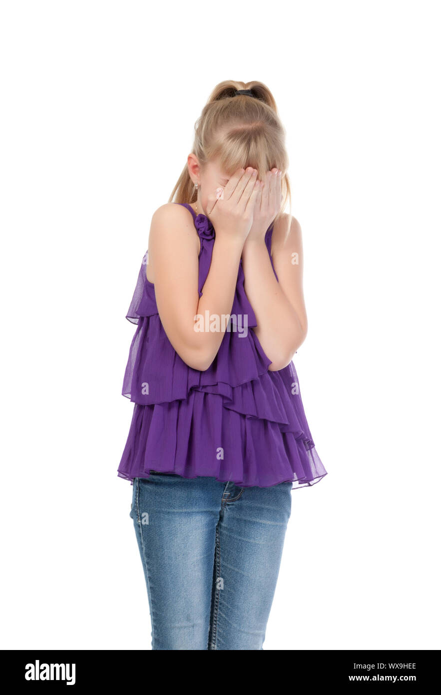 Young girl shyly covered her face with her hands Stock Photo - Alamy