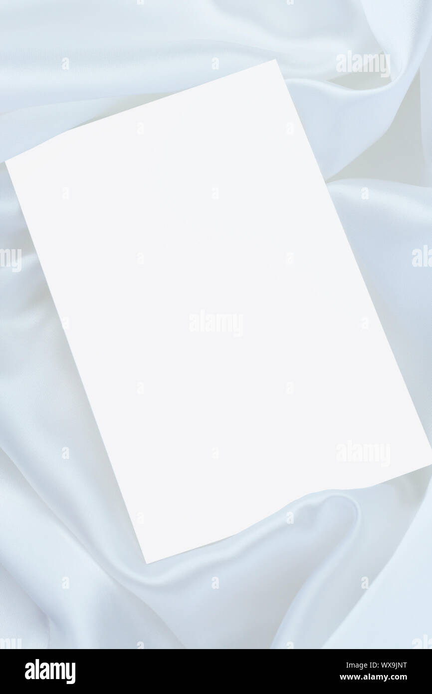 White blank card on white satin Stock Photo - Alamy
