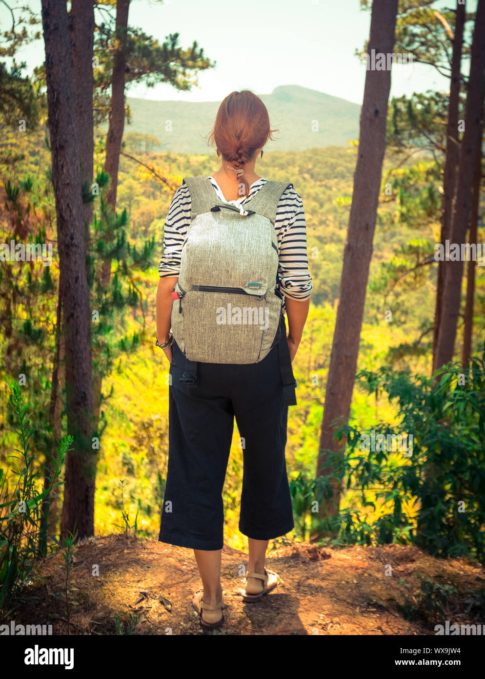 Tourist with backpack in highland Stock Photo - Alamy