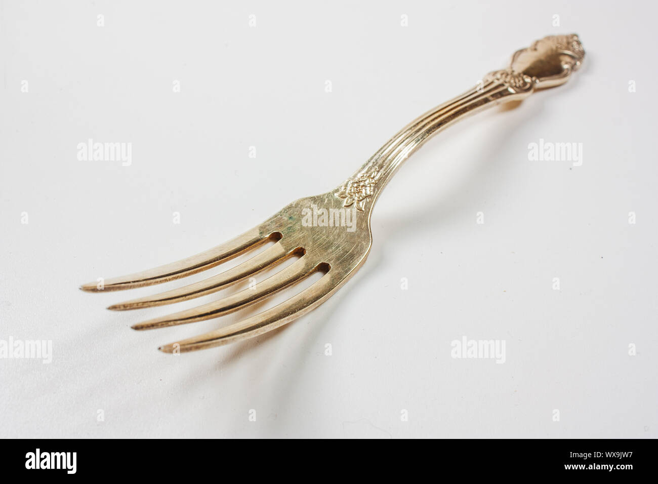 Golden fork isolated on white background Stock Photo - Alamy