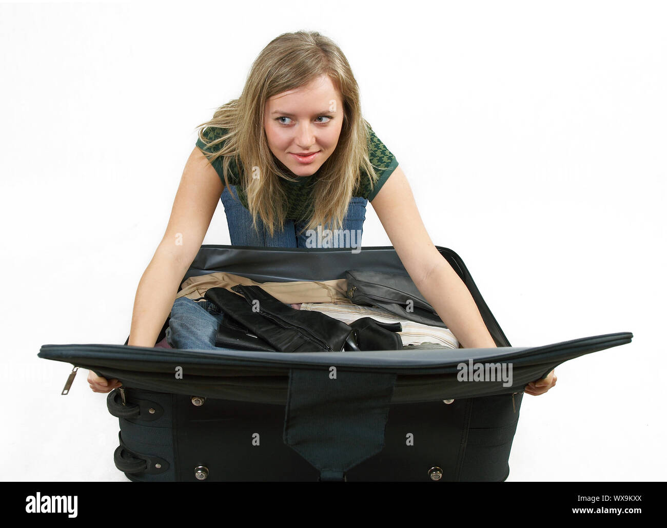 girl is packing clothes on bag Stock Photo - Alamy
