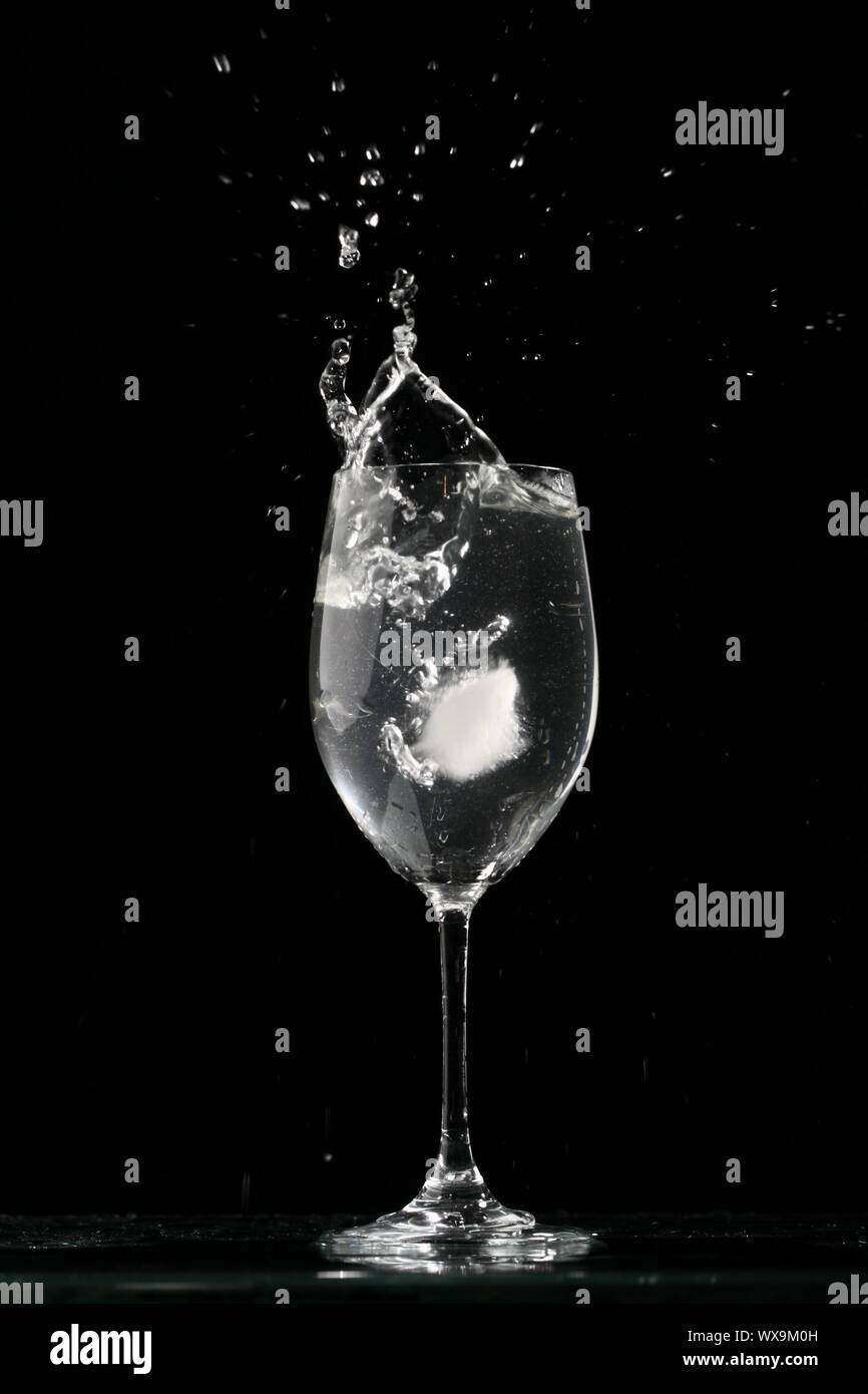 alcohol splash on black background Stock Photo - Alamy