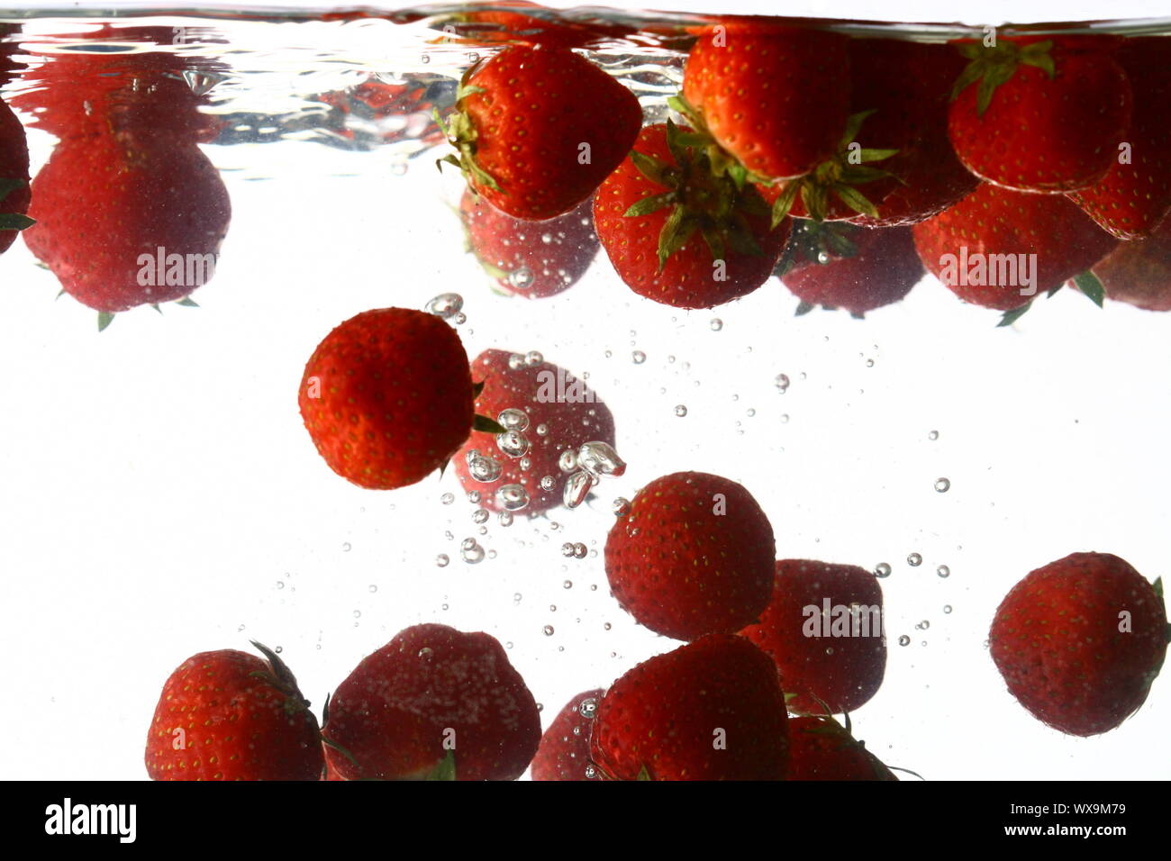 strawberry splash in water isolated on white background Stock Photo - Alamy