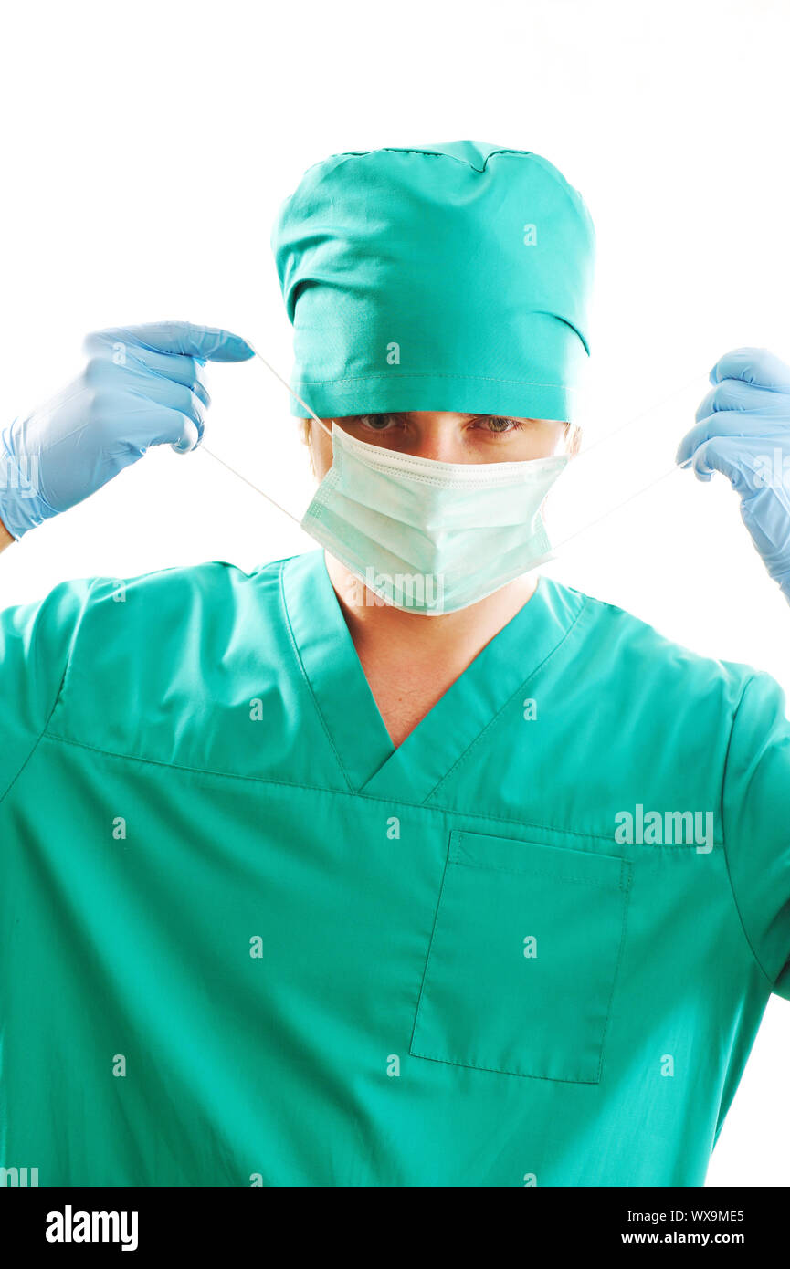 Doctor pulling on surgical mask Stock Photo - Alamy