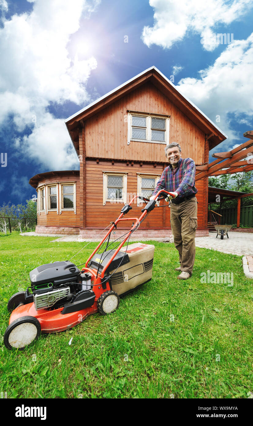Senior man mowing the lawn Stock Photo - Alamy