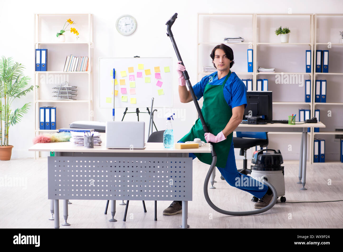 Male handsome professional cleaner working in the office Stock Photo ...