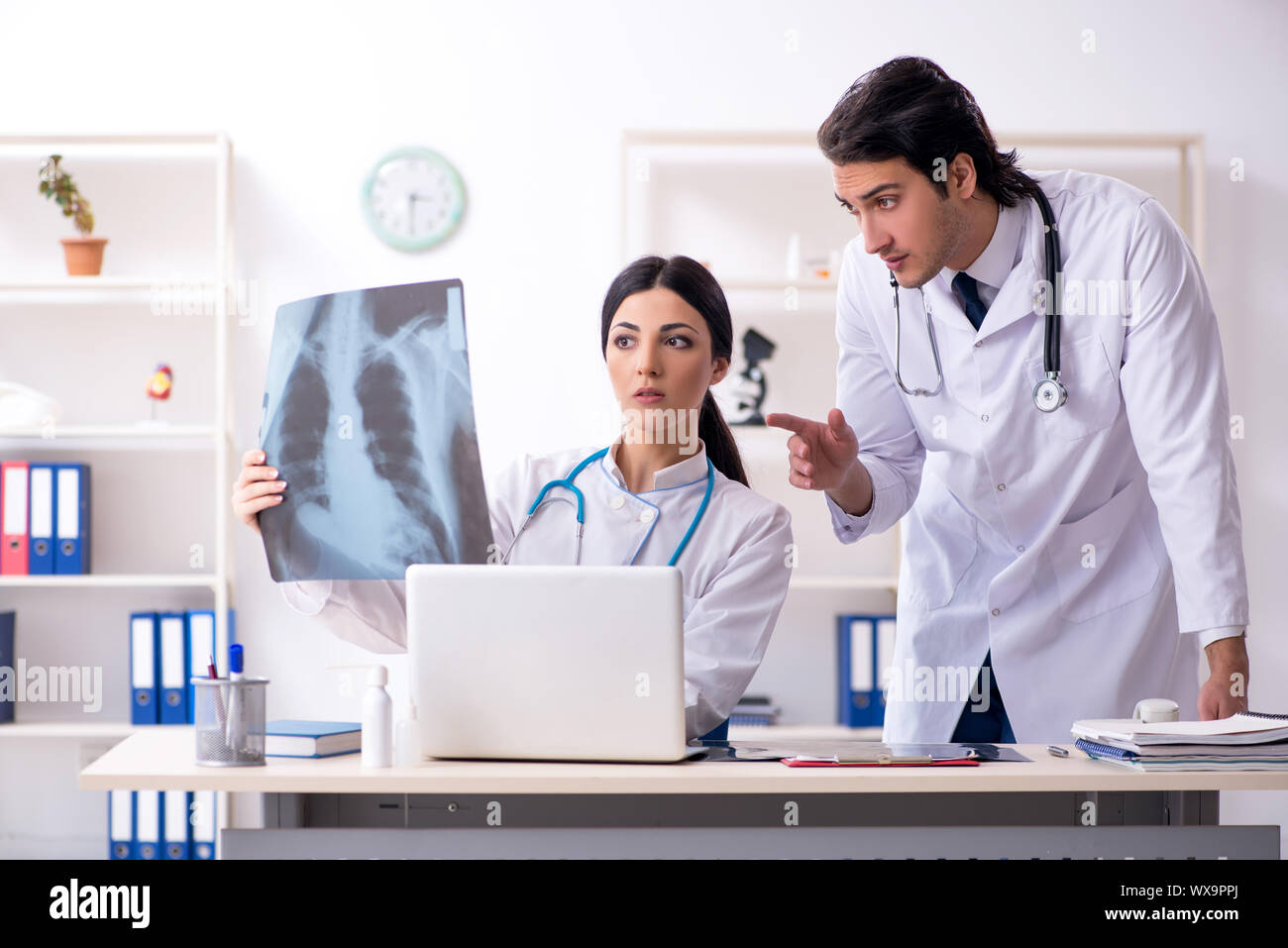 Two young doctors working in the clinic Stock Photo - Alamy
