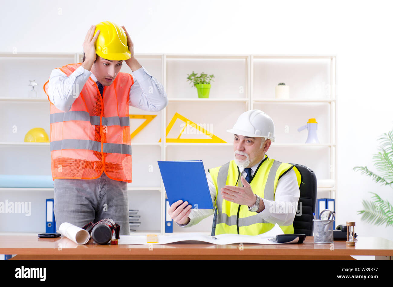Two engineers colleagues working under project Stock Photo - Alamy