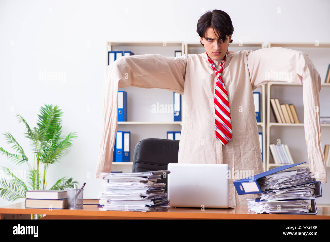 Crazy young man in straitjacket at the office Stock Photo - Alamy
