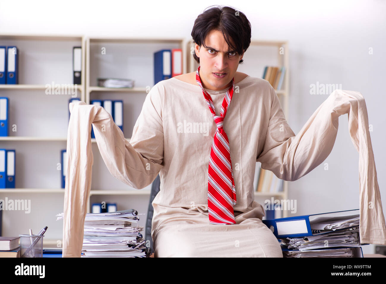 Crazy young man in straitjacket at the office Stock Photo - Alamy