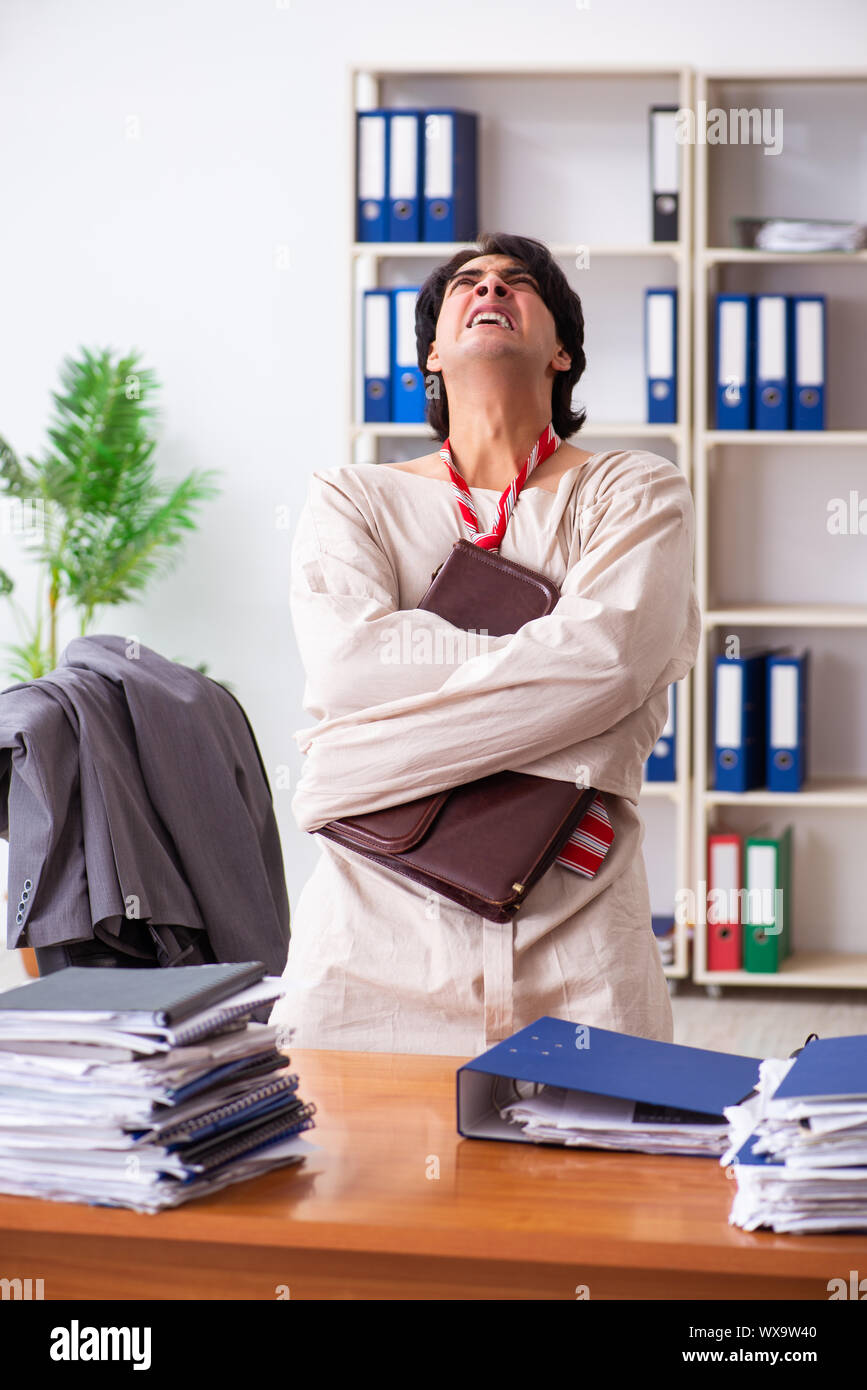 Crazy young man in straitjacket at the office Stock Photo - Alamy
