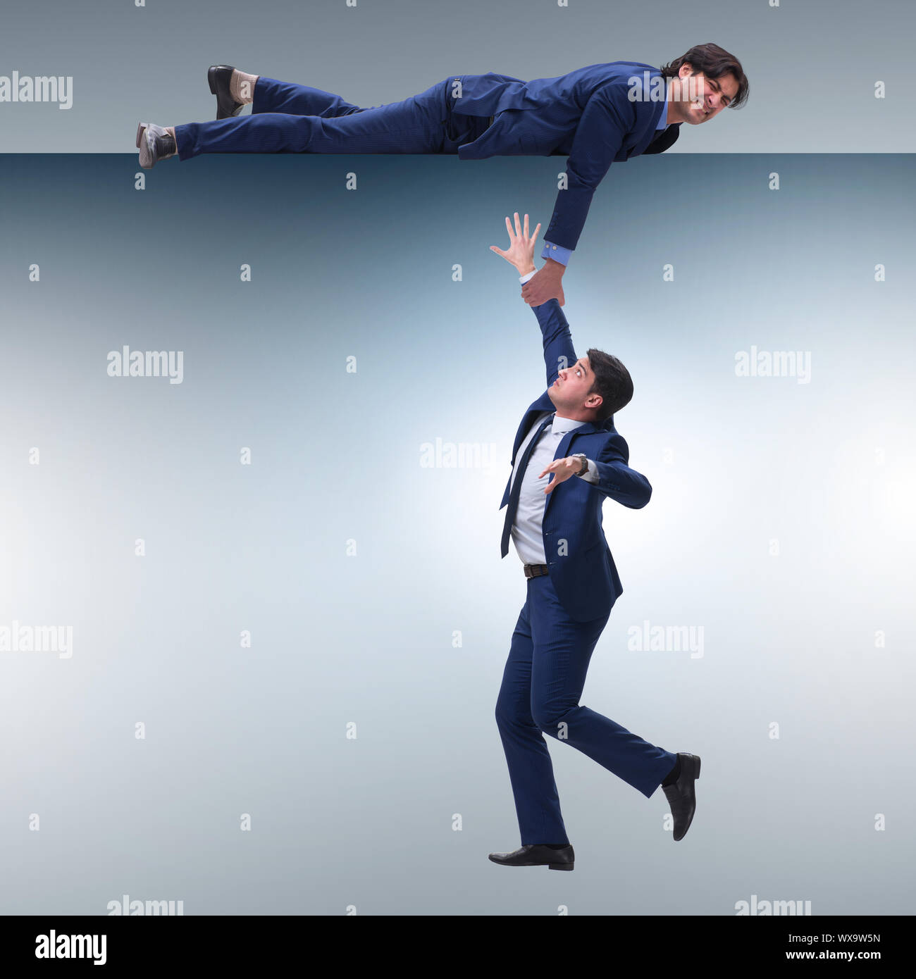 Businessman pulling falling hi-res stock photography and images - Alamy